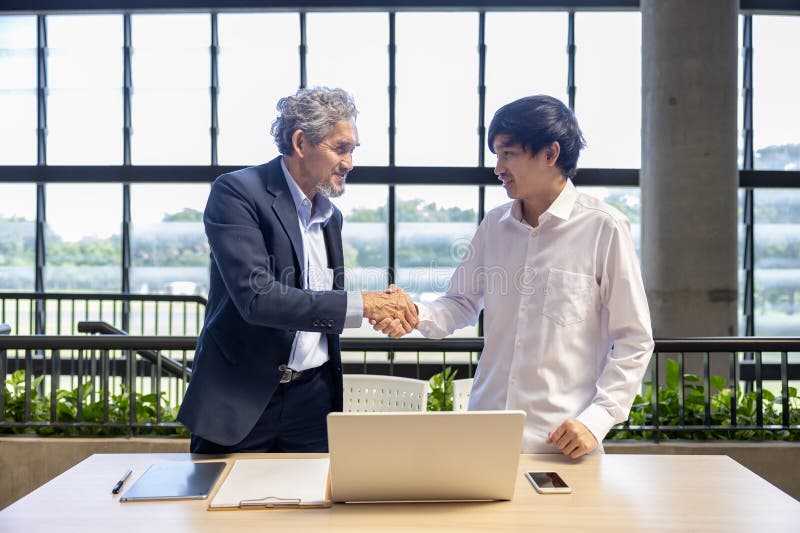 Senior Asian Executive Manager is Handshaking with the New Trainee ...