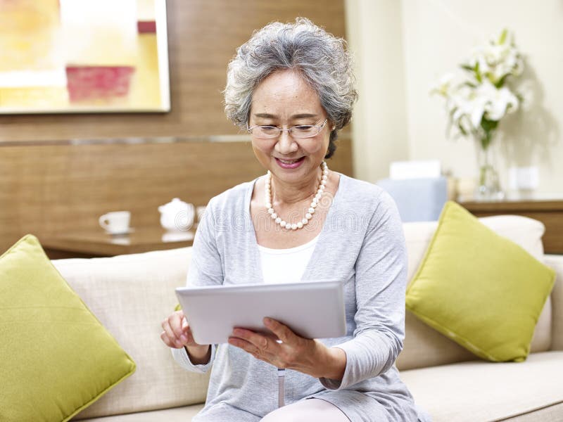 Senior Asian Woman Using Tablet Computer Stock Photo - Image of east ...