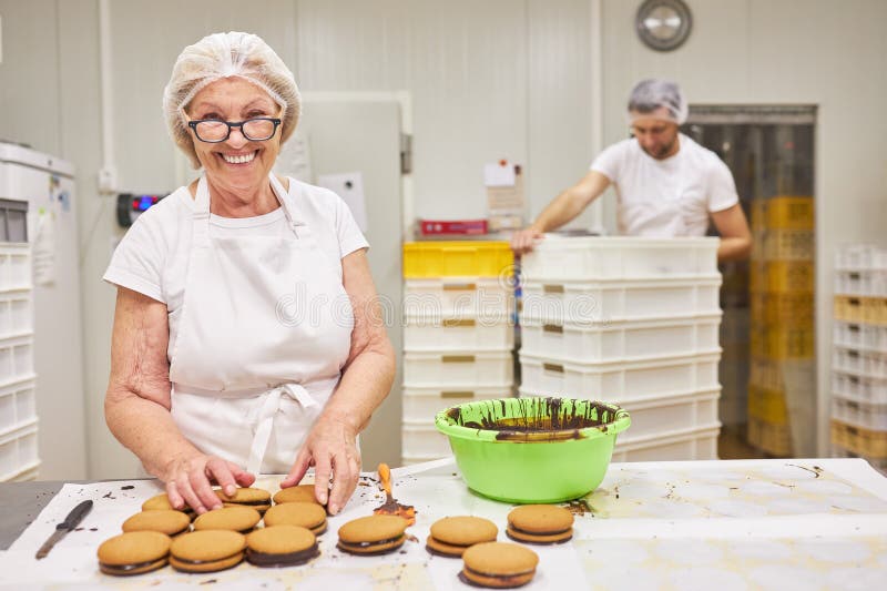 Senior Baker Decorates Sandwich Biscuits with Chocolate Stock Image ...