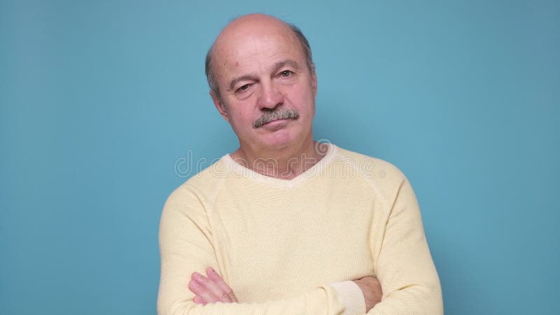 Senior Bald Sad Man Looking at Camera. Blue Background. Stock Photo ...