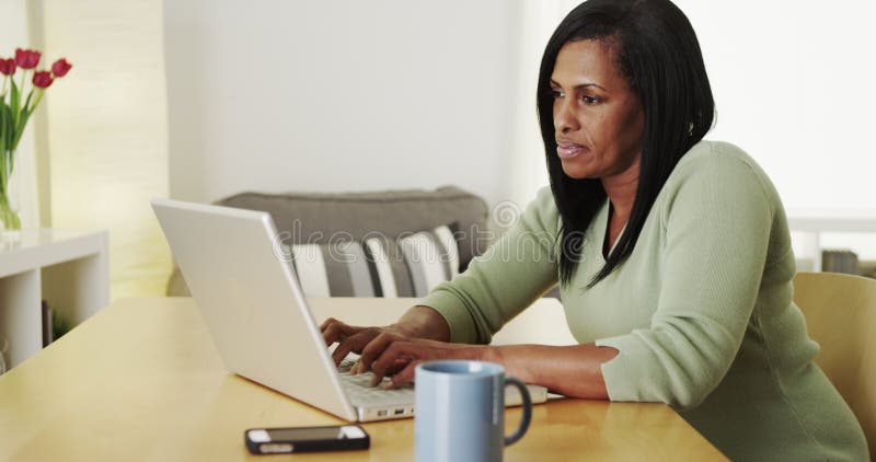 Senior Black Woman Working on Laptop Computer at Desk Stock Video ...