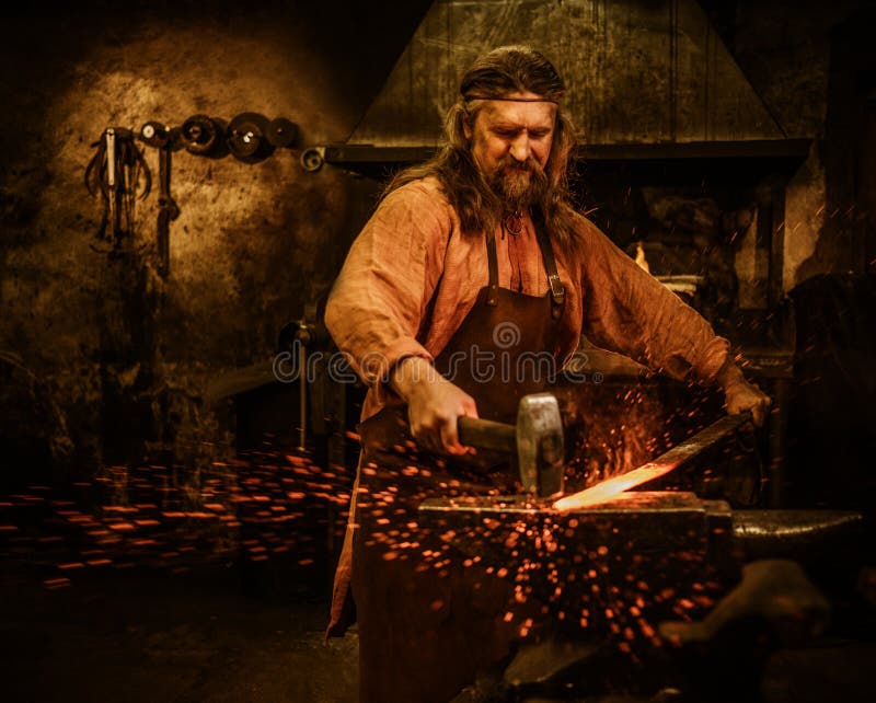 Senior Blacksmith Forging the Molten Metal on the Anvil in Smithy Stock ...