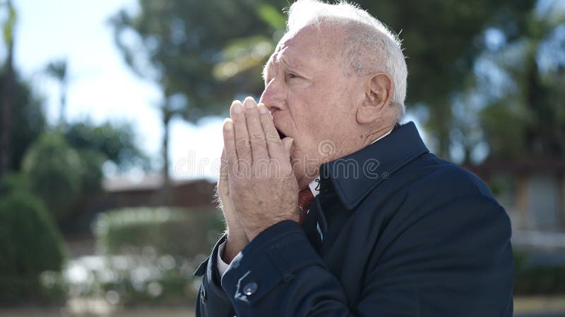 Senior Blowing Air on Hands for Cold at Park Stock Photo - Image of ...
