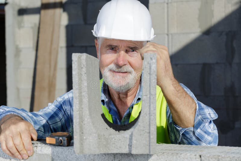 Senior Builder Holds Cement Block Stock Photo - Image of improvement ...