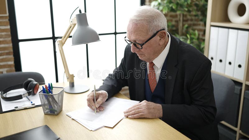 Senior Business Worker Writing on Documents at Office Stock Photo ...
