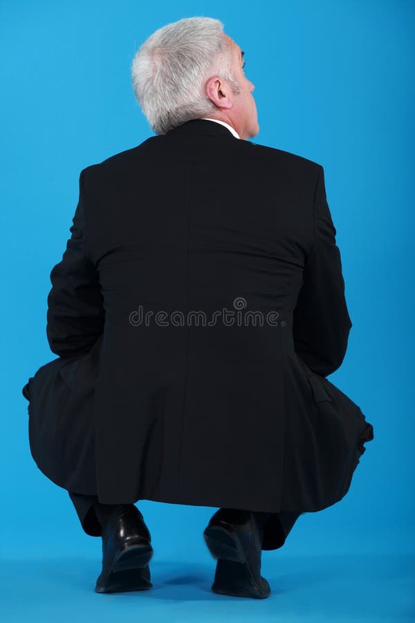 Senior Businessman Crouching Stock Photo - Image of looking, adult ...