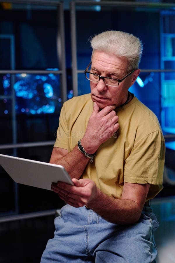 Senior Businessman Looking through Data on Tablet Screen Stock Photo ...