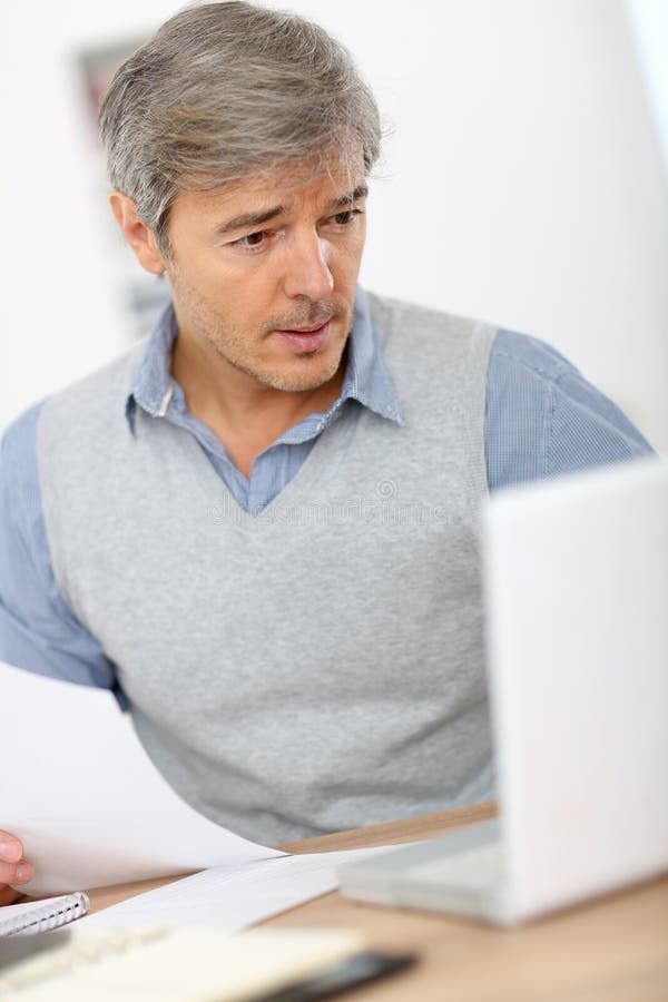 Senior Businessman at Office Working on Laptop Stock Photo - Image of ... Senior Businessman at Office Working on Laptop Stock Photo - Image of ...