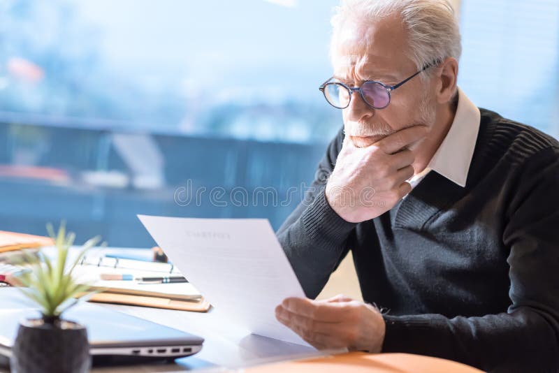 Senior Businessman Reading a Document Stock Image - Image of reading ...