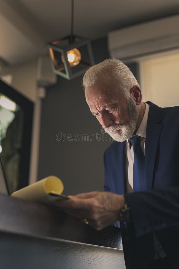 Senior Businessman Taking Notes Stock Photo - Image of itinerary ...