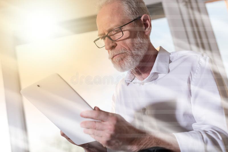 Senior Businessman Using a Digital Tablet, Light Effect Stock Photo ...
