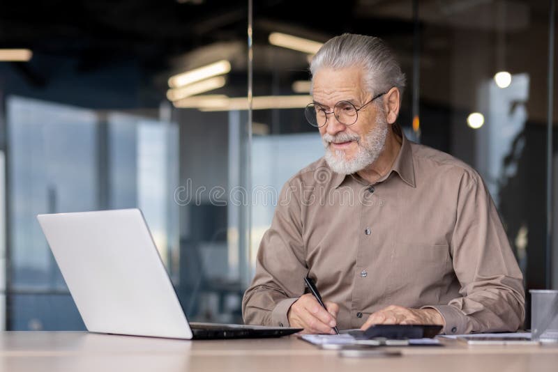 Senior Business Professional Working on Laptop in Modern Office Stock ...