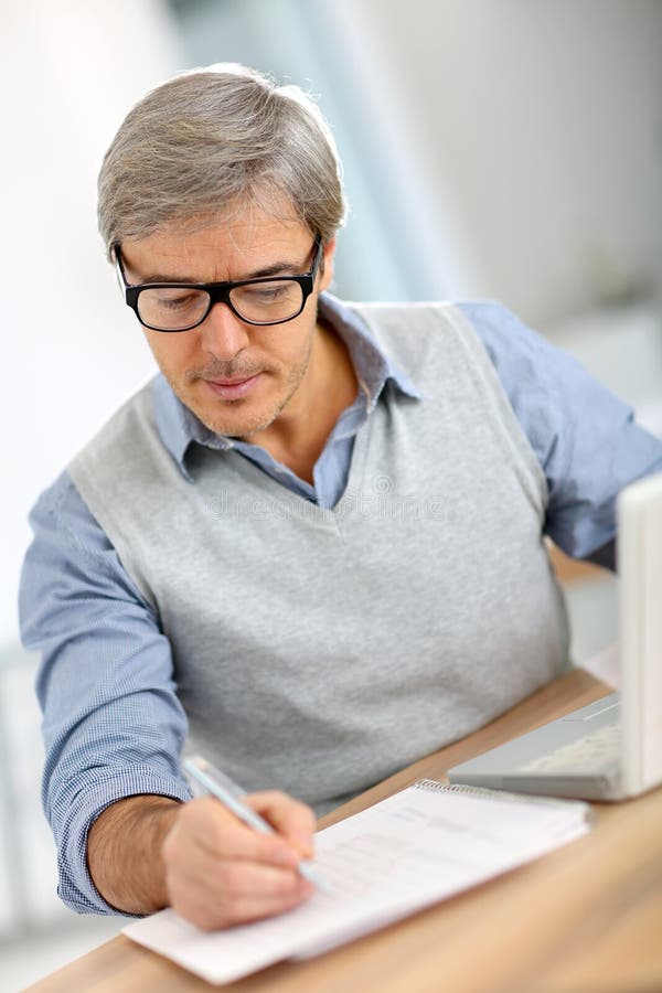 Senior Businessman Writing Down Notes Stock Image - Image of sitting ...
