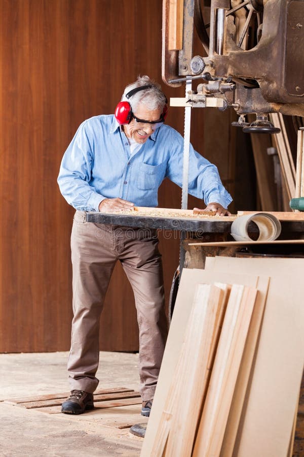 Senior Carpenter Cutting Wood with Bandsaw Stock Photo - Image of blade ...