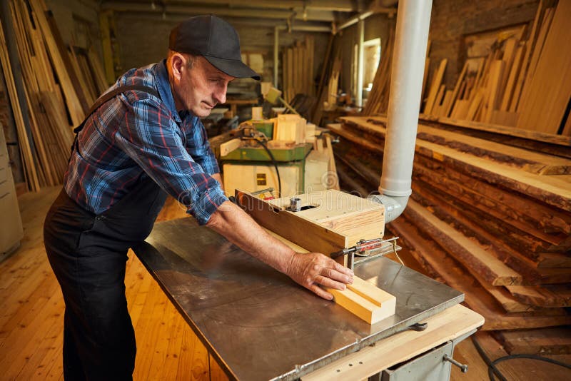 Senior Carpenter in Uniform Works on a Woodworking Machine at the ...