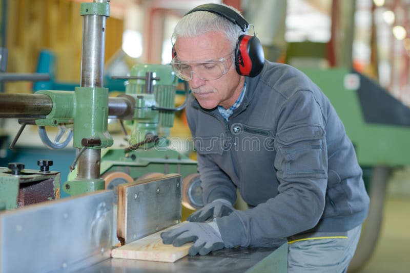 Senior Carpenter Using Machinery Stock Image - Image of workplace ...