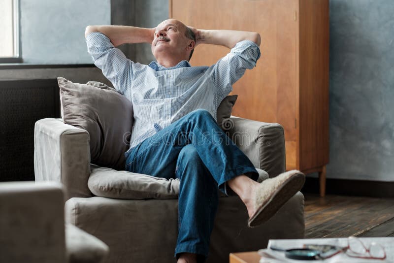 Senior Man Relaxing in Sofa at Home Sitting Alone Stock Photo - Image ...