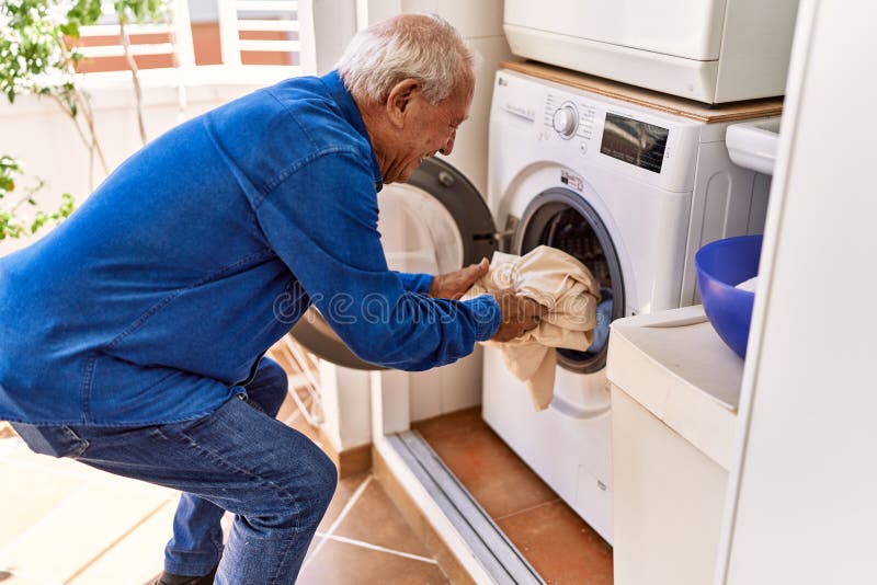 Senior Caucasian Man Smiling Happy Doing Laundry at the Terrace Stock ...