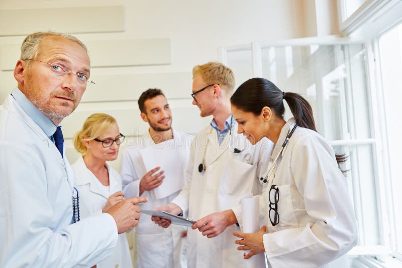 Senior Chief Doctor with Team Stock Photo - Image of technology, staff ...