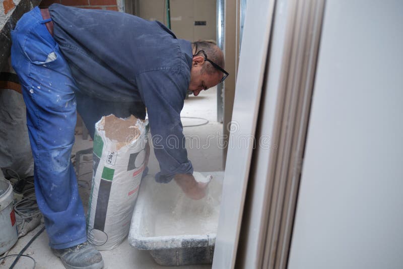 Senior Constructor Worker Preparing Tile Adhesive Mortar. Stock Image ...