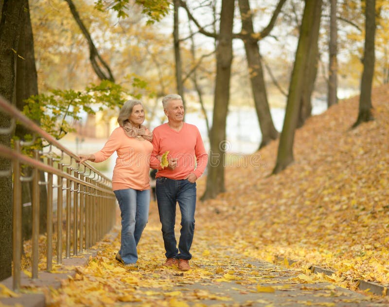 Senior Couple Walking Along Autumn Path Stock Image - Image of loving ... Senior Couple Walking Along Autumn Path Stock Image - Image of loving ...