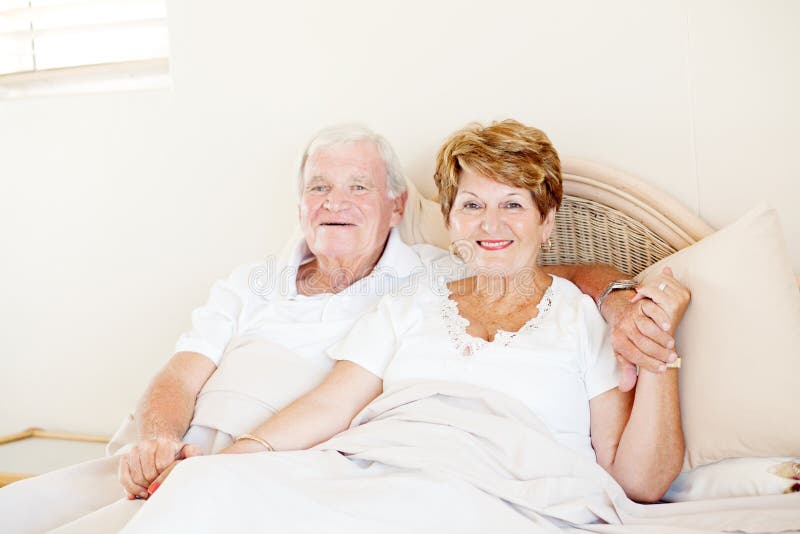 Senior couple in bed stock image. Image of holding, love - 23459481