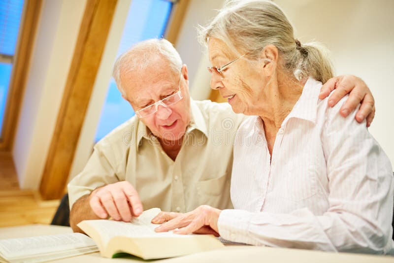 Senior Couple with Book Reading and Reading Aloud Stock Photo - Image ...