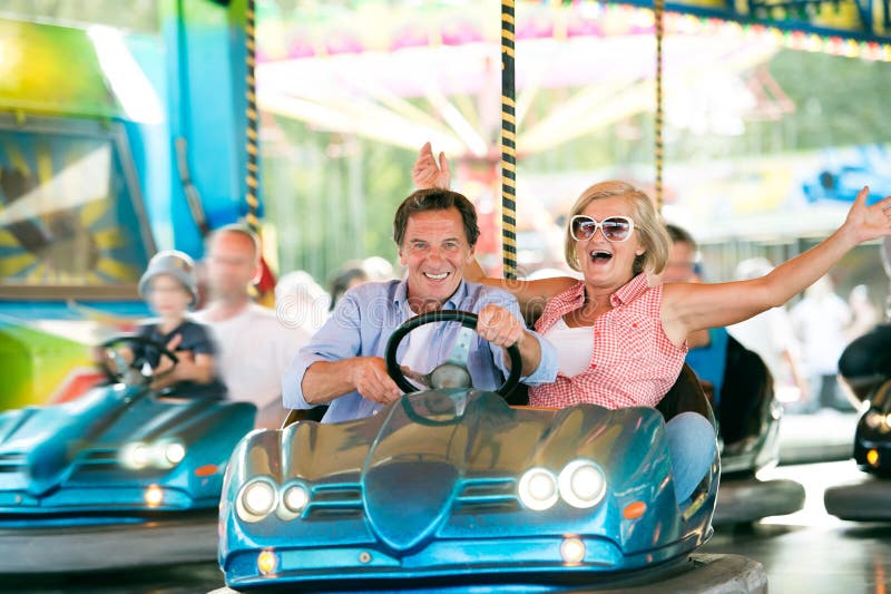 Senior Couple in the Bumper Car at the Fun Fair Stock Photo - Image of ...