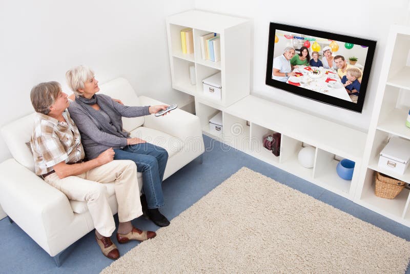 Senior Couple Changing Channel of Television Stock Image - Image of ...