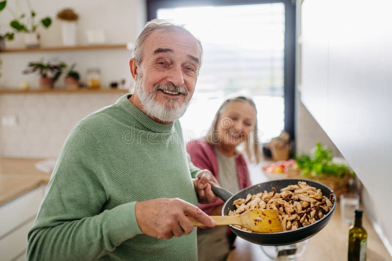 Senior Couple Cooking Together in Their Kitchen. Stock Photo - Image of ...