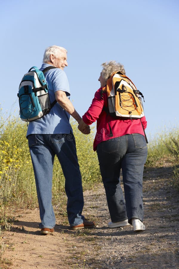 Senior Couple on Country Walk Stock Photo - Image of holding, path ...