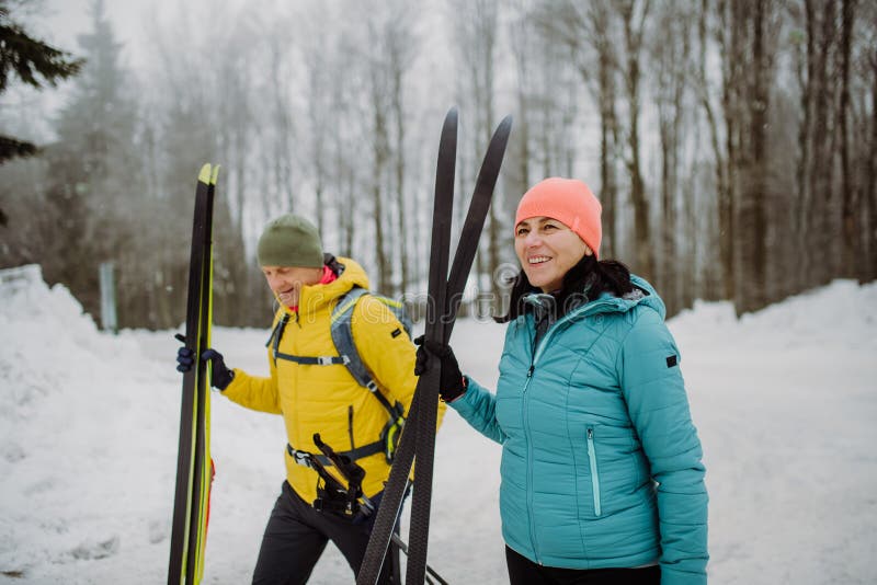 Senior Couple Crossing Forest with Skis in Hands. Stock Image - Image ...
