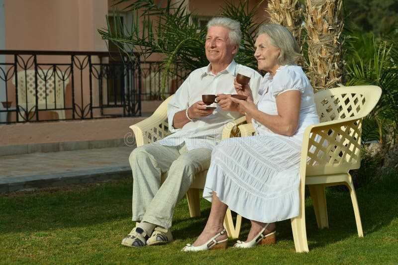 Senior Couple Drinking Tea in Garden Stock Photo - Image of portrait ...