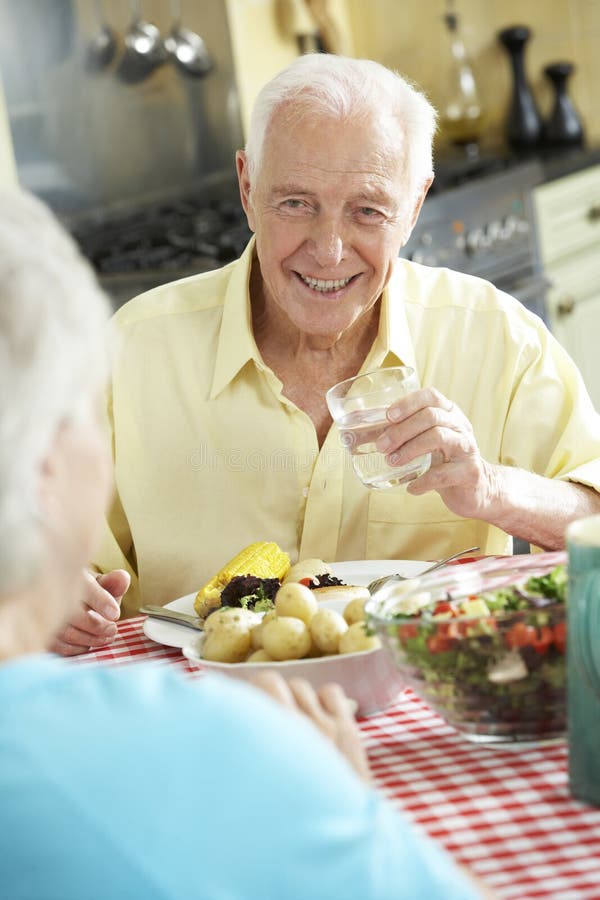 Senior Couple Eating Meal Together in Kitchen Stock Image - Image of ...