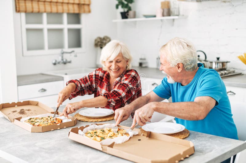 Senior Couple Eating Pizza in the Kitchen Stock Image - Image of happy ...