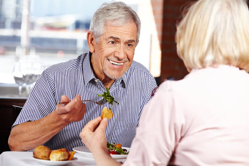 Senior Couple Eating in Restaurant Stock Image - Image of senior ...