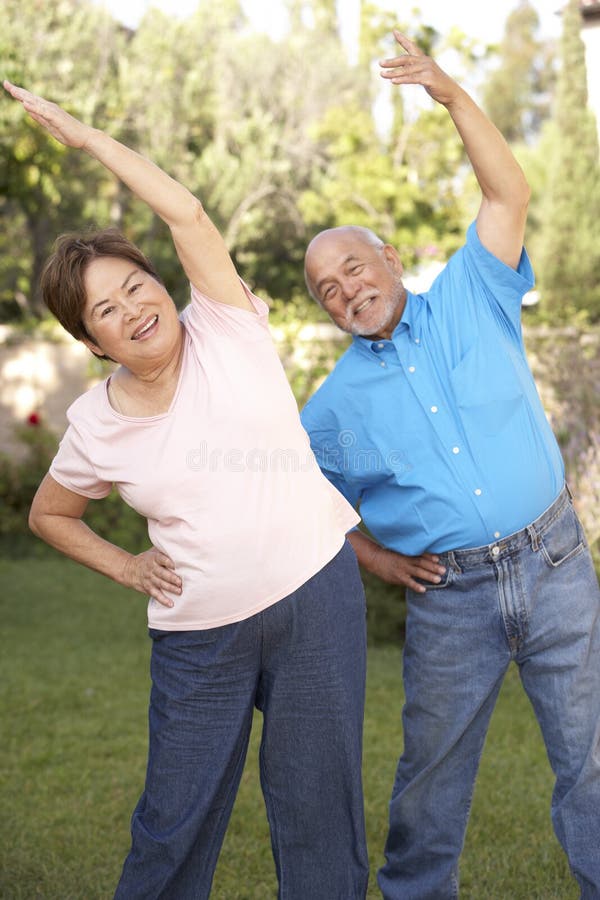 Senior Couple Exercising in Garden Stock Image - Image of length ...