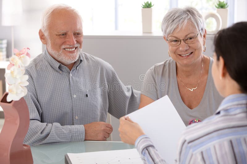 Senior Couple at Financial Advisor Smiling Stock Photo - Image of group ...