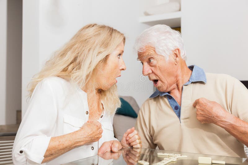 Senior couple arguing stock photo. Image of dominoes - 182437266