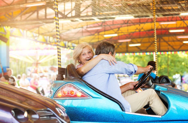 Senior Couple at the Fun Fair Stock Photo - Image of funfair, bumper ...