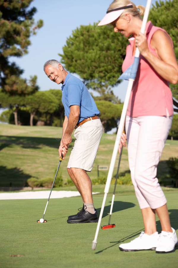 Senior Couple Golfing on Golf Course Stock Photo - Image of club ...