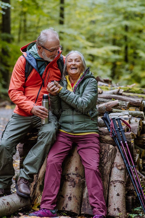 Senior Couple Having Break during Hiking in Autumn Forest. Stock Photo ...