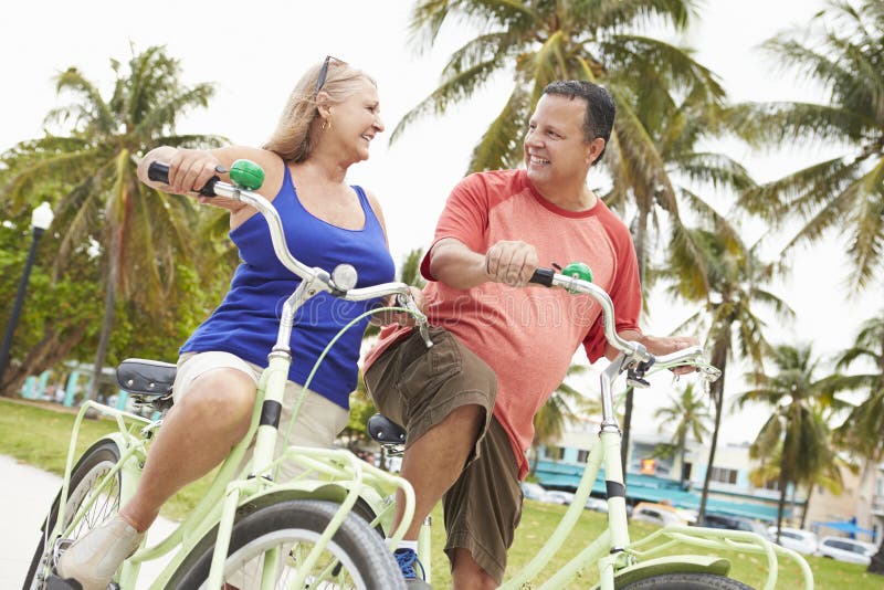 Senior Couple Having Fun on Bicycle Ride Stock Photo - Image of seniors ...