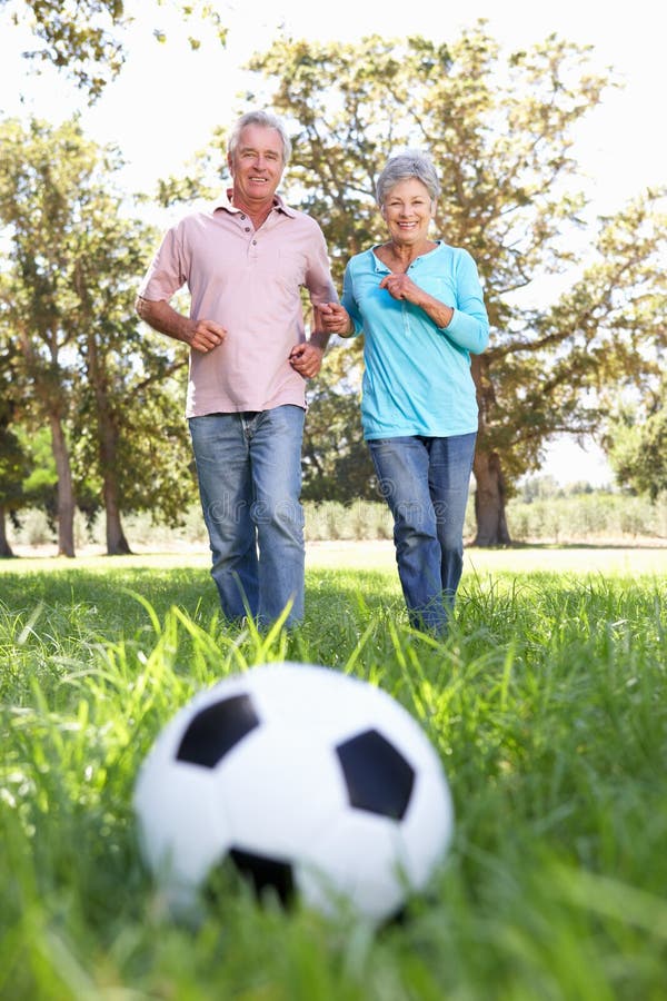 Senior Couple Having Fun Playing Football Stock Image - Image of ...