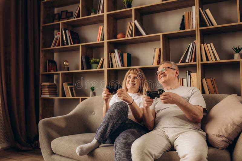 Senior Couple Having Fun Playing Video Games. Stock Image - Image of ...
