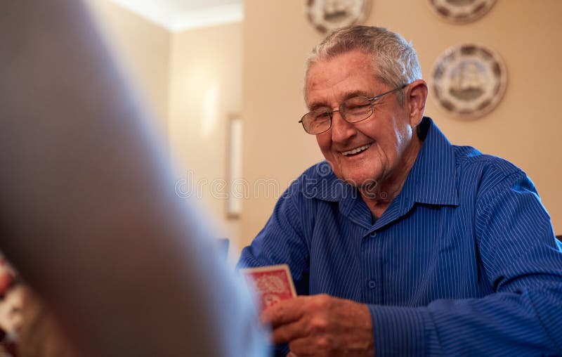 Senior Couple at Home Sitting at Table Playing Cards Together Stock ...