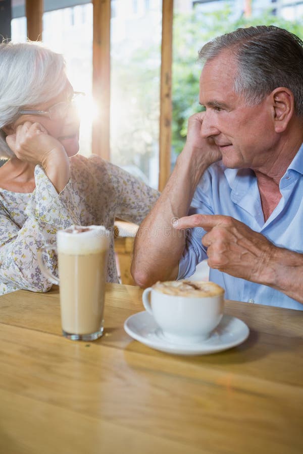 Senior Couple Interacting while Having Coffee Stock Photo - Image of ...