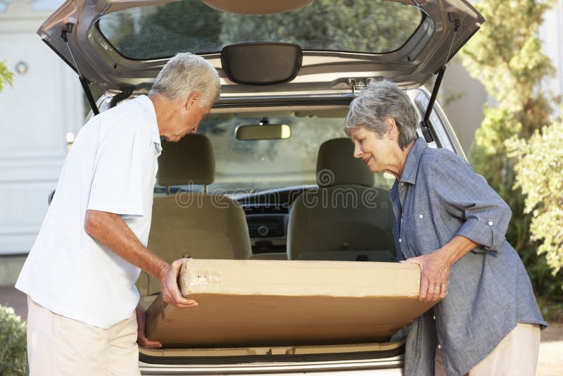 Senior Couple Loading Large Package into Back of Car Stock Image ...