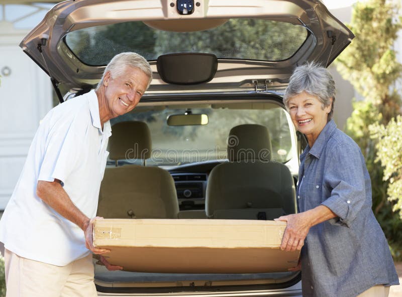 Senior Couple Loading Large Package into Back of Car Stock Image ...