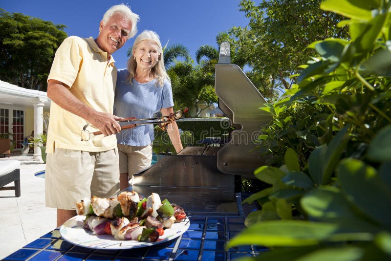 Senior Couple Outside Cooking Summer Barbecue Stock Image - Image of ...